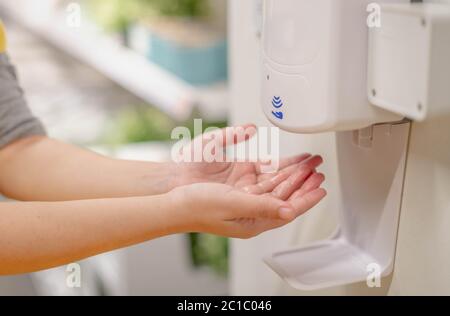 The automatic alcohol dispenser in front of the public area ...