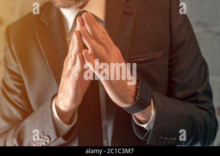 Confident businessman steepling gesture, fingers pressed in steeple ...