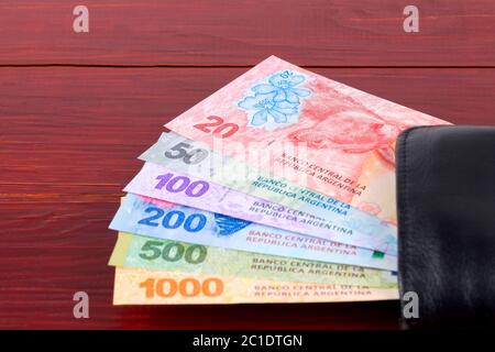 Argentine peso in the black wallet Stock Photo - Alamy