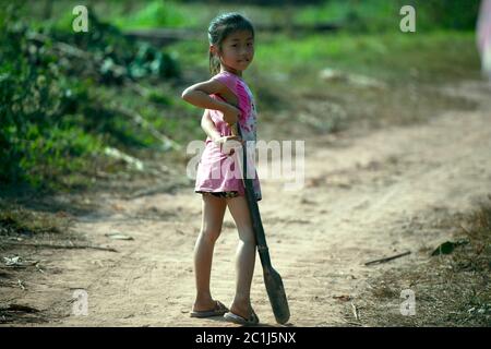A young, indigenous, ethnic Tai Deng girl in her village in Luang ...