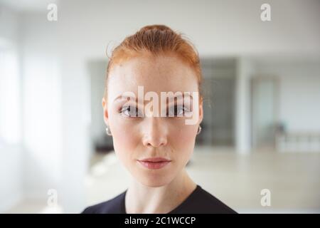 Caucasian female ballet dancer staring into the camera with a serious ...
