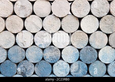 Pile of concrete cylinder bricks. Storage of cylindrical cement samples ...