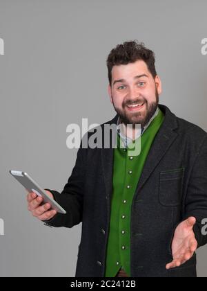 young and cool austrian man with black hair and beard in traditional ...