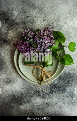 Table setting with beautiful bouquet of lilac as floral decoration and ...