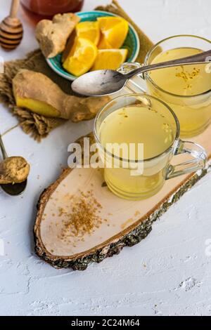 Detox drink with organic lemon, ginger and mint on dark background with ...