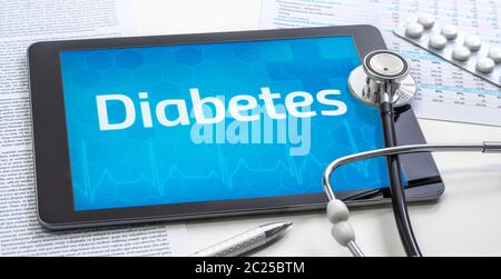 Medical tablet and text Diabetes on screen on wooden table Stock Photo ...