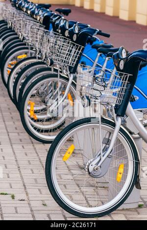 Parked blue urban bicycles on rental station Stock Photo - Alamy
