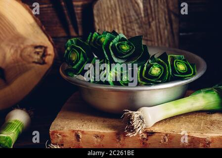 Fresh leek in a metal bowl on rustic kitchen Stock Photo - Alamy