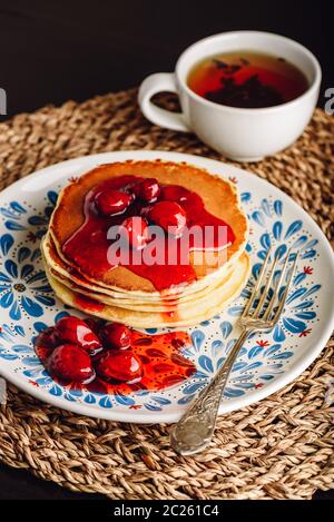 Stack of pancakes with dogberry jam on white plate with ornate Stock ...