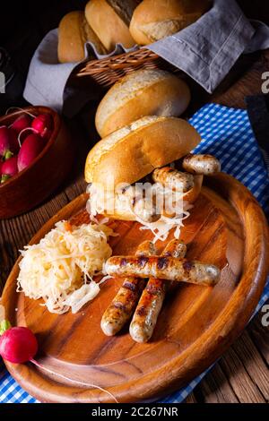 rustic Thuringian bratwurst with sauerkraut and roll Stock Photo - Alamy