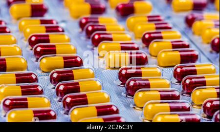 Red-yellow capsule in blister pack. Antibiotic capsule pills ...