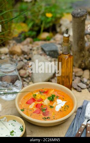 Simple and spicy chicken curry, outside cooking near beautiful garden ...
