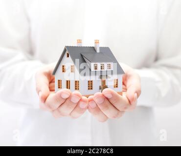 Small toy house in hands Stock Photo - Alamy