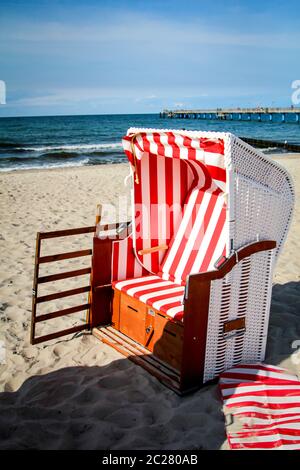 Red beach basket chair on sandy seashore on a sunny day Stock Photo - Alamy