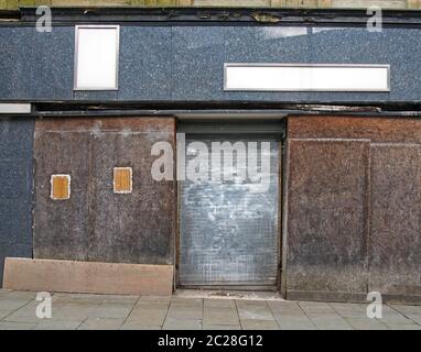 Boarded up window and door of commercial building Stock Photo - Alamy