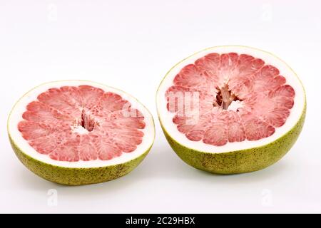 Closeup view of cut pink pomelo on a white background Stock Photo - Alamy