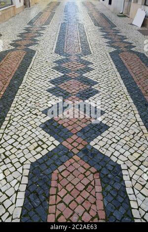 Typical pavement mosaic on the pavement (pavement) in the city centre ...