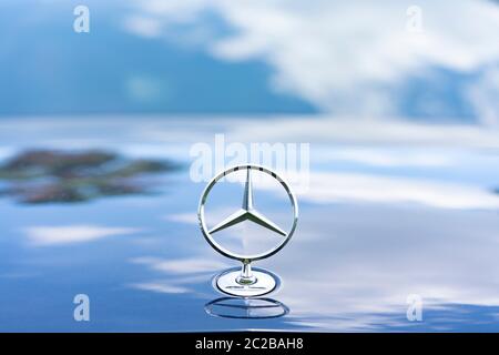 Mercedes Benz logo close up on a car grill. Mercedes-Benz is a German automobile manufacturer ...