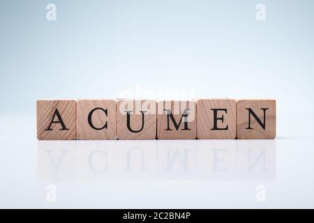 Acumen Word Made With Wooden Blocks On Reflective Desk Stock Photo - Alamy