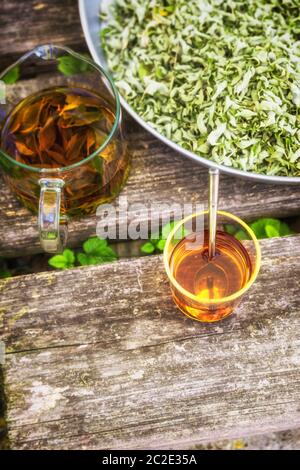 verbena tea on old wooden planks Stock Photo - Alamy