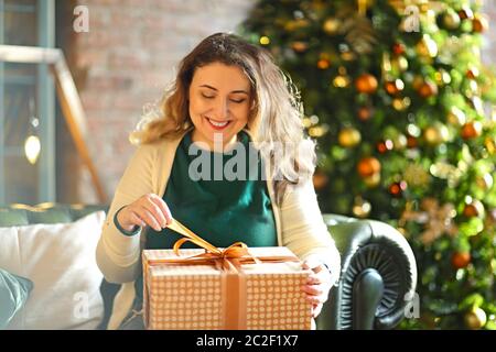 happy woman with christmas gift over lights Stock Photo - Alamy