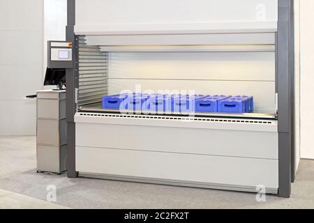 Automated vertical tower storage carousel in warehouse Stock Photo - Alamy