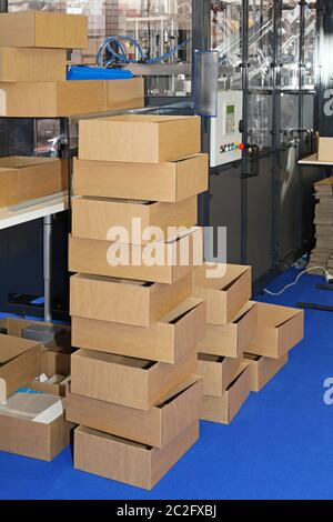 Production line and big pile of boxes Stock Photo - Alamy