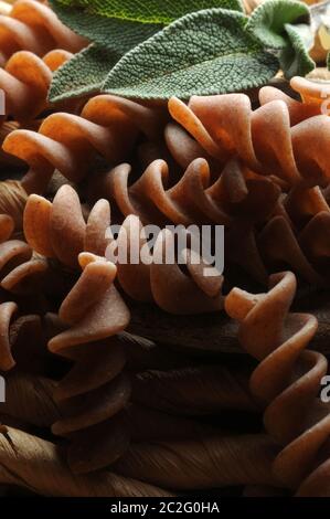 Organic uncooked Buckwheat Fusilli pasta on a dark background Stock ...