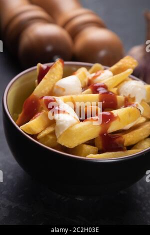 Canadian poutine, fried potato chips with cheese and gravy or sauce ...