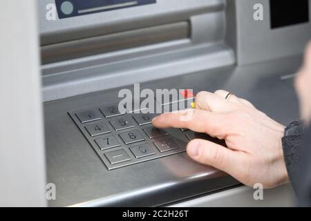 Closeup male hand dials pin code on terminal Stock Photo - Alamy