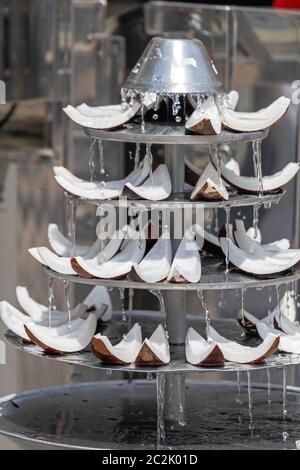 Pouring Water Over Pieces of Coconut Tower Stock Photo - Alamy