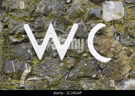 White 3d WC Sign at Stone Wall Stock Photo - Alamy
