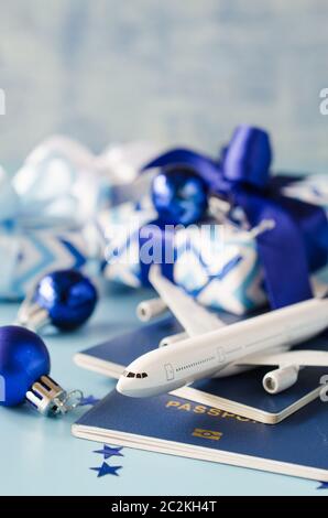 Christmas airplane travel concept. Passports, toy white plane. Gift box ...