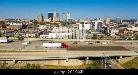 Cars and trucks traverse the urban jungle and maze of highway around ...