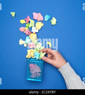 Top view of a small garbage bin full with used tissue paper, on wooden ...