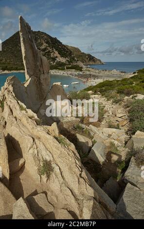 A vertical shot of a pool on the shore of a beach with the sea in the ...