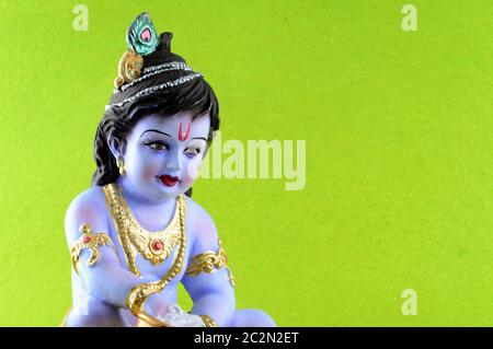 Hindu God Krishna on green background Stock Photo - Alamy