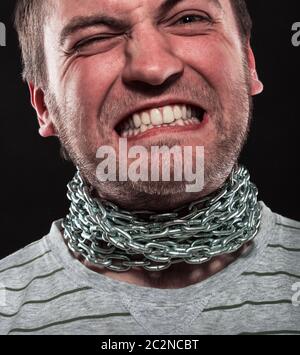 Screaming man with iron chain around neck Stock Photo - Alamy