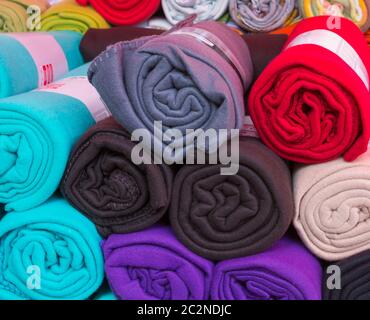 Many rolled colorful fleece blankets Stock Photo - Alamy