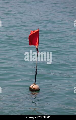 Floating Red Flag Mark in Harbour Water Warning Stock Photo - Alamy