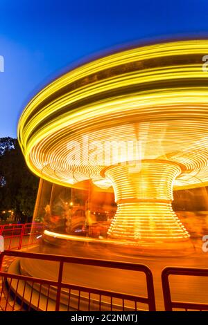 Fast merry-go-round lighting in the night park Stock Photo - Alamy