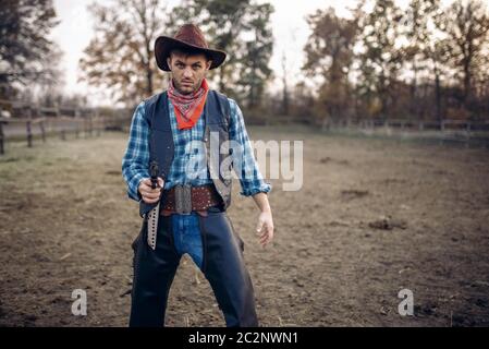 Cowboy with revolver makes quick shot, gunfight on texas ranch, western ...