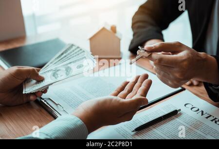 Home agents are handing out keys to home buyers who are signing ...