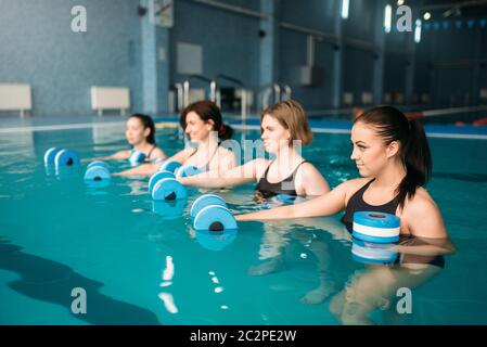 Women doing a water aerobics class outside in the hotel swimming Stock ...