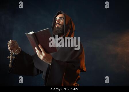 Medieval monk with spellbook calling the spirits, secret ritual ...