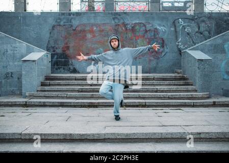 Rap performer posing on the steps, street dancing. Modern urban dance style. Male dancer Stock ...
