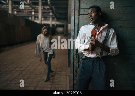Frightened man hides from zombie, apocalypse Stock Photo - Alamy