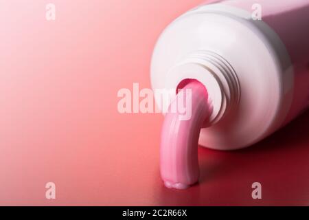 Pink toothpaste squeezing out of tube Stock Photo - Alamy