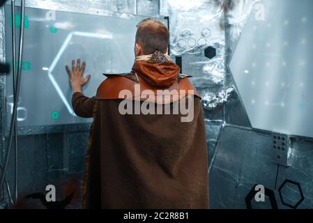 Intergalactic space scientist enter data on the teleport board ...