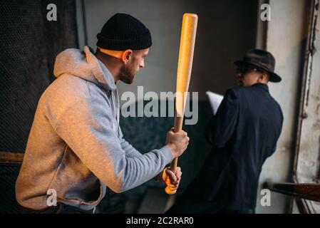 Male robber with baseball bat attact his victim. Street hooligan ...